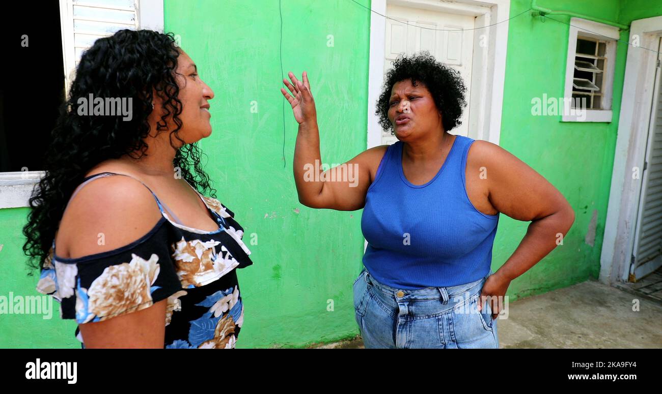 Hispanic women gossiping in emotional conversation. Latinas talk Stock ...