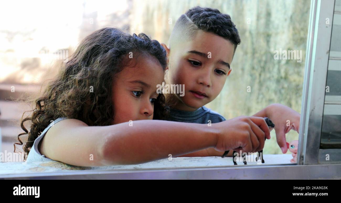 Little kids playing with toys. Small siblings play with toy. Hispanic ...