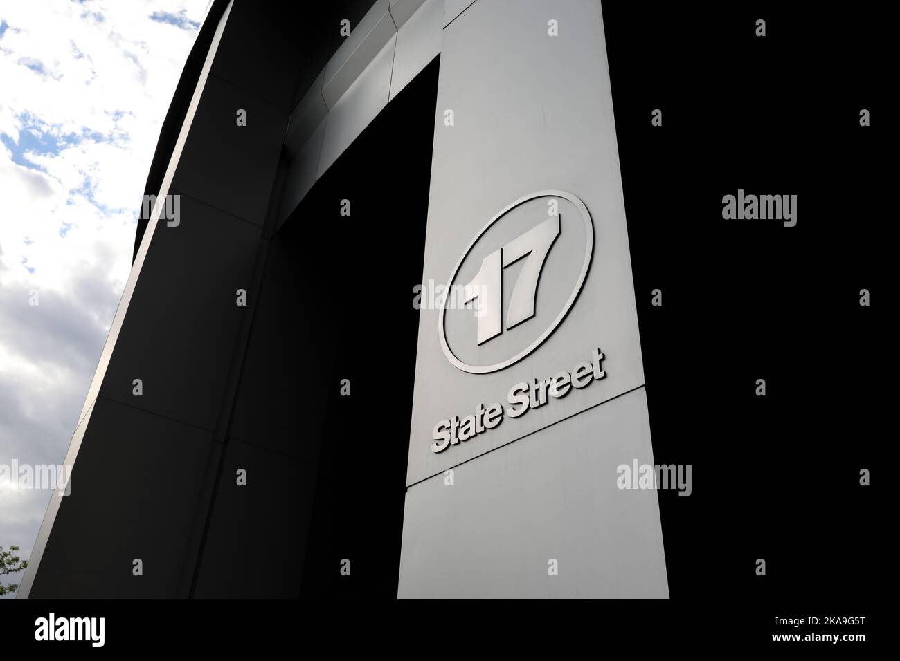 A low angle shot of signage for 17 State Street on a black modern ...