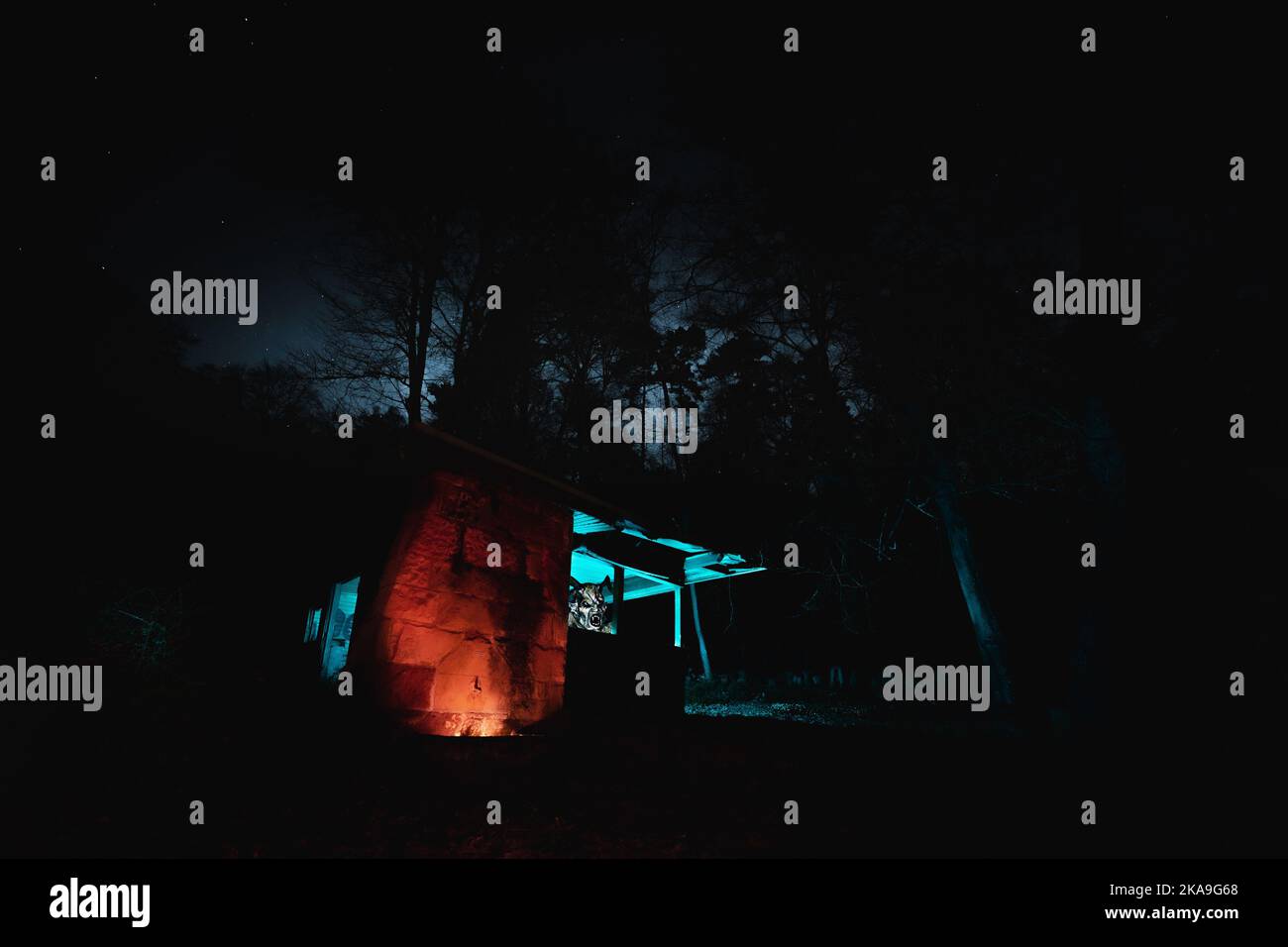 The veranda and the wall of the house, illuminated by light at night ...