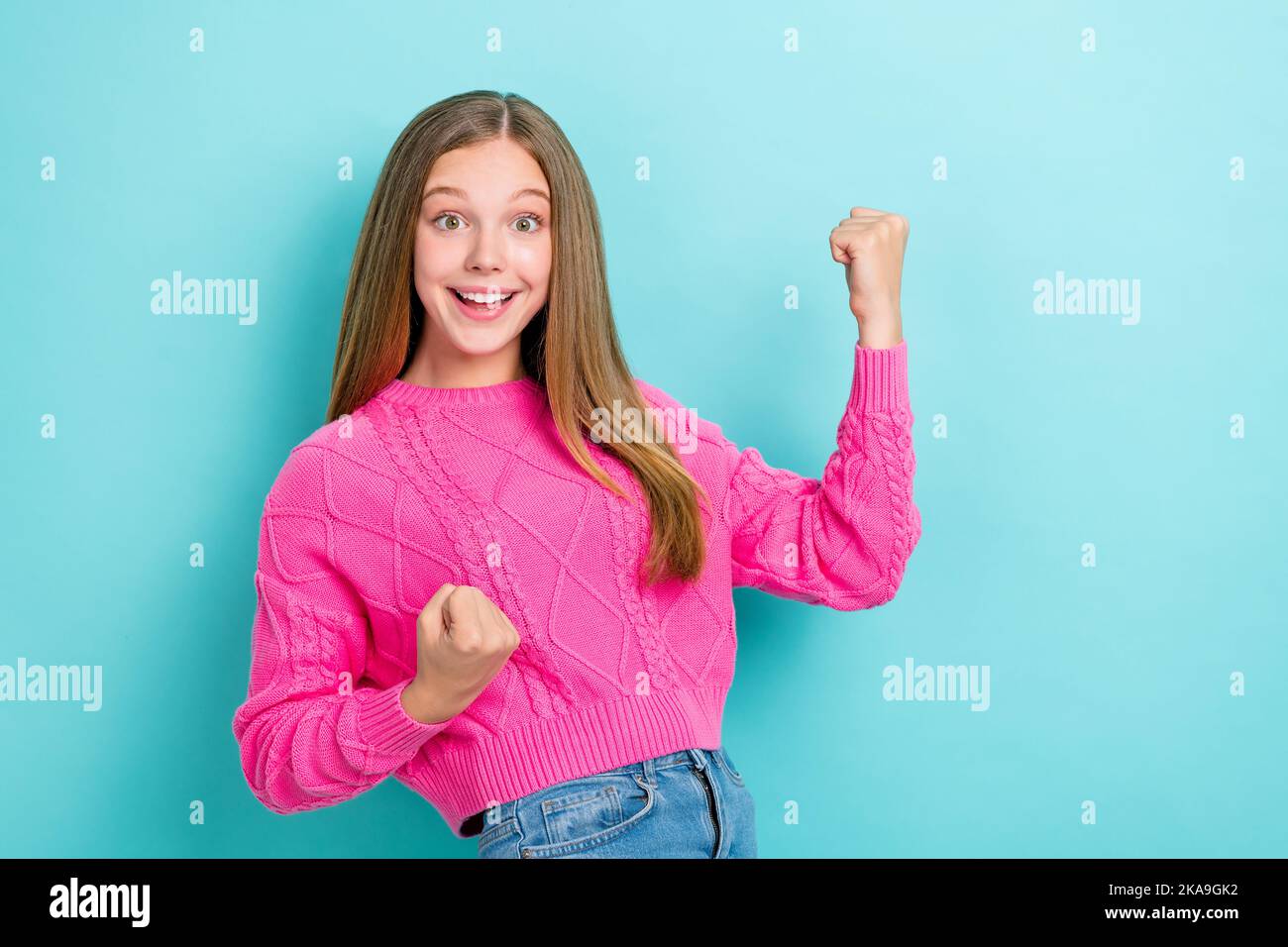 Photo of brown hair teenager schoolgirl wear pink sweater fists up ...