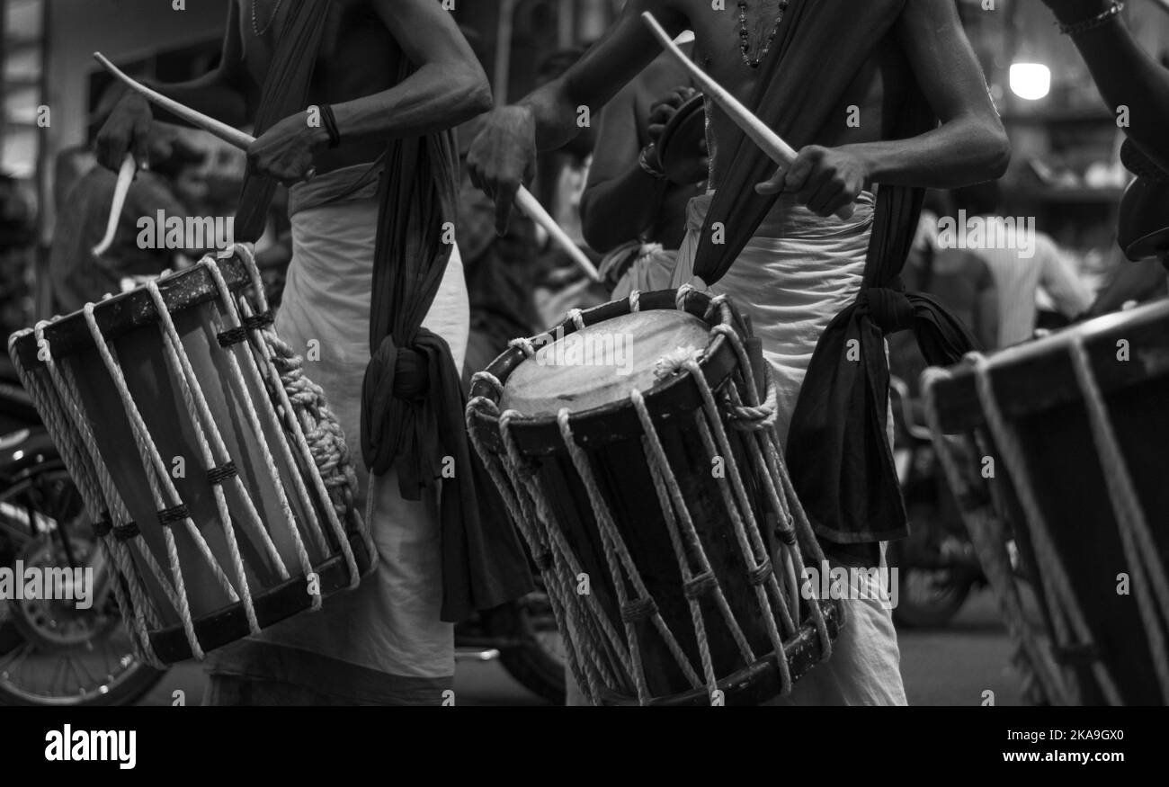A closeup shot of a Indian men playing traditional percussion drum ...