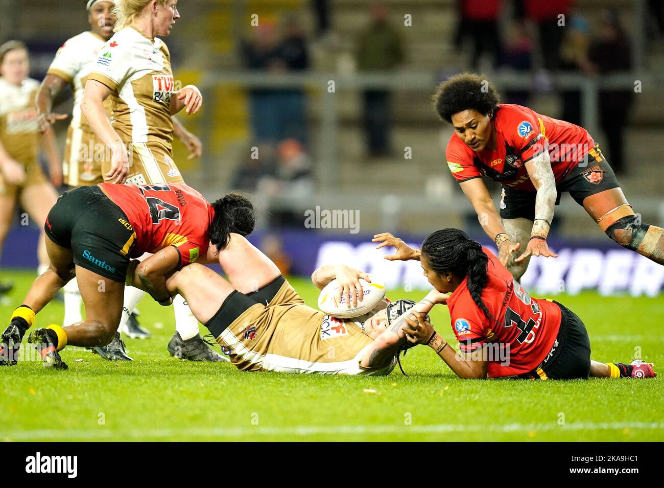 Canada's Laura Mariu is tackled by Papua New Guinea's Ua Ravu (left ...