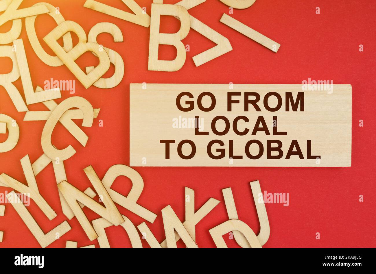 Business and finance concept. On a red background, there are wooden ...