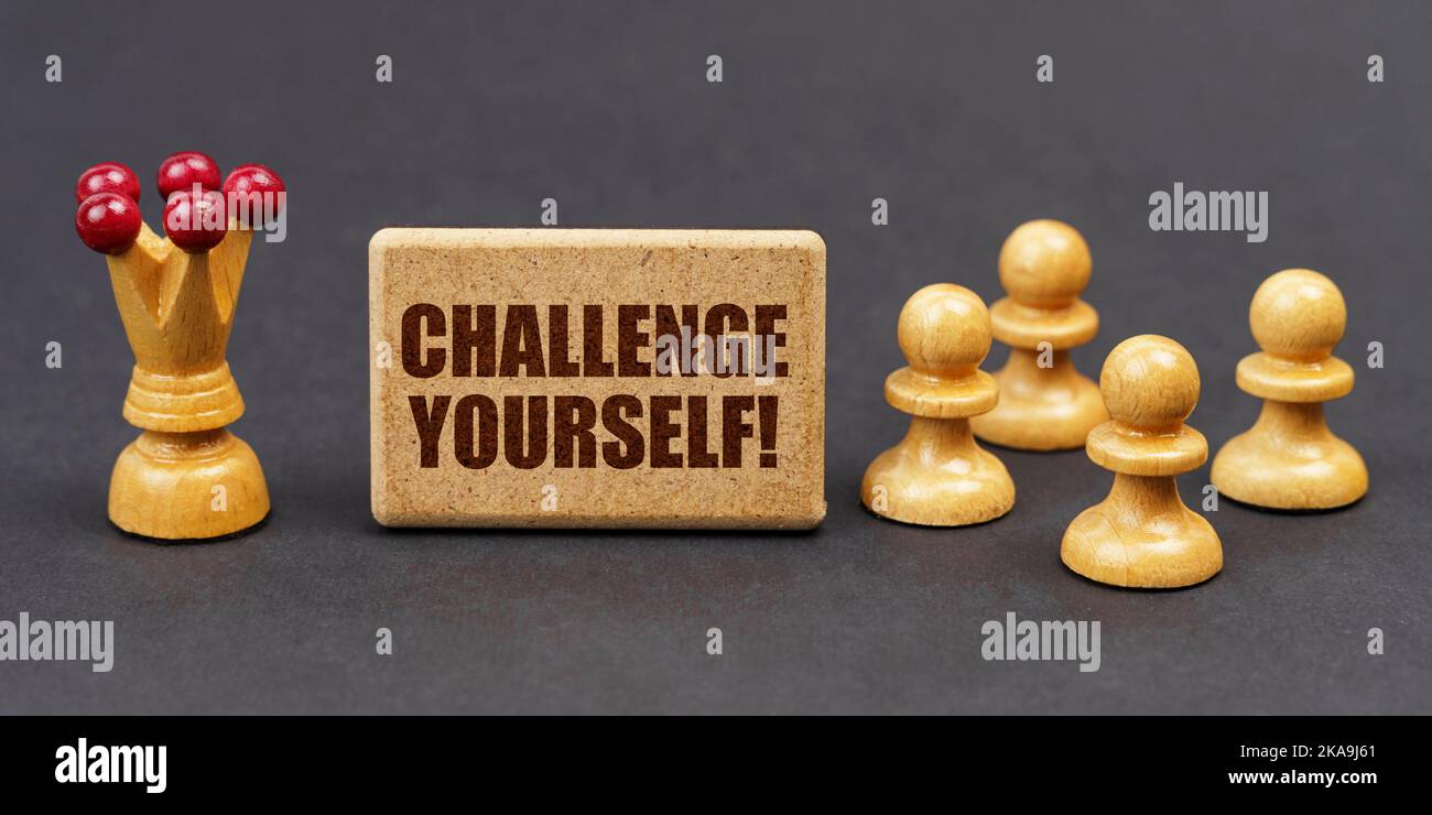 Business concept. On a black background, chess and a sign with the ...