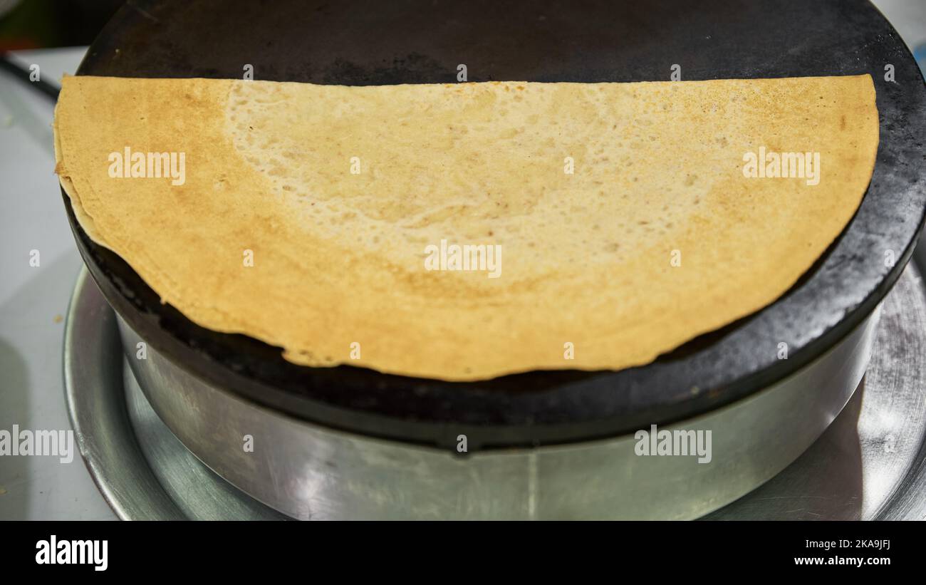 Making delicious crepes on a grill with fruit and chocolate Stock Photo ...