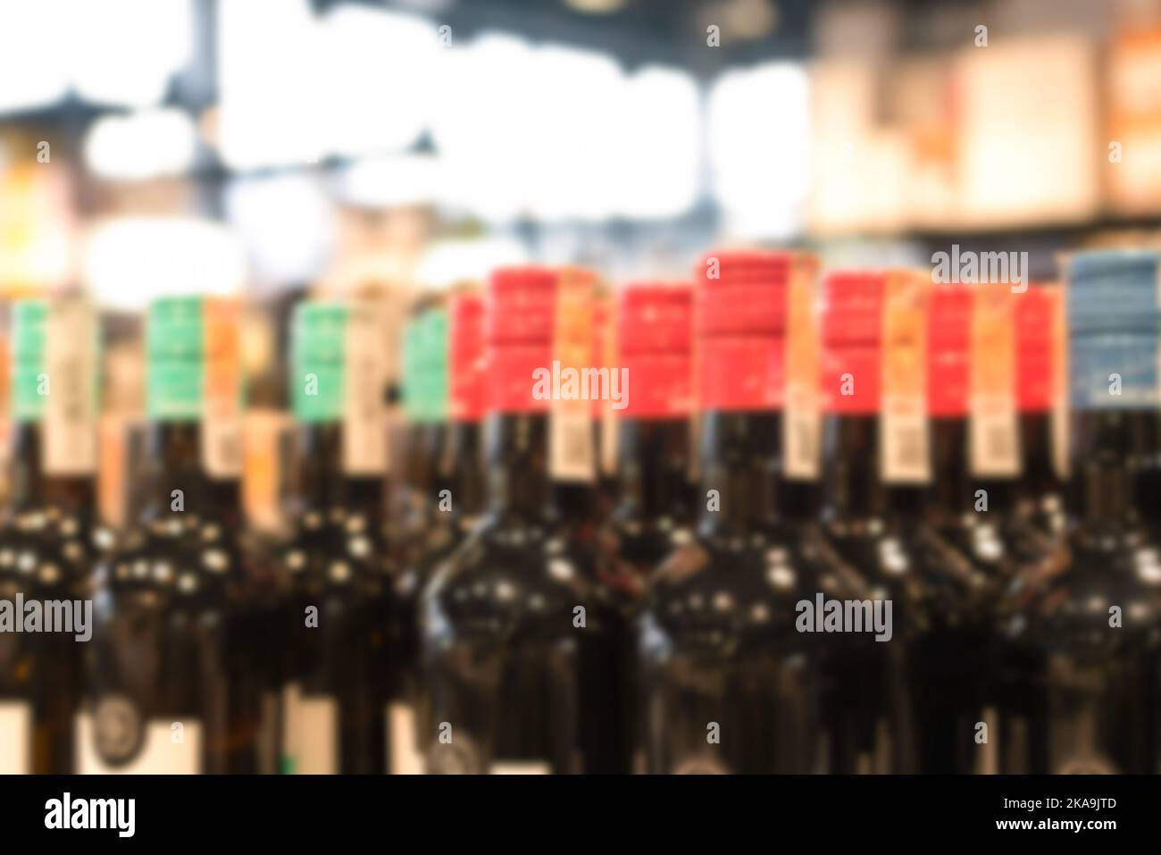 Blur liquor store background. Many blurred bottles with alcohol. Wine ...