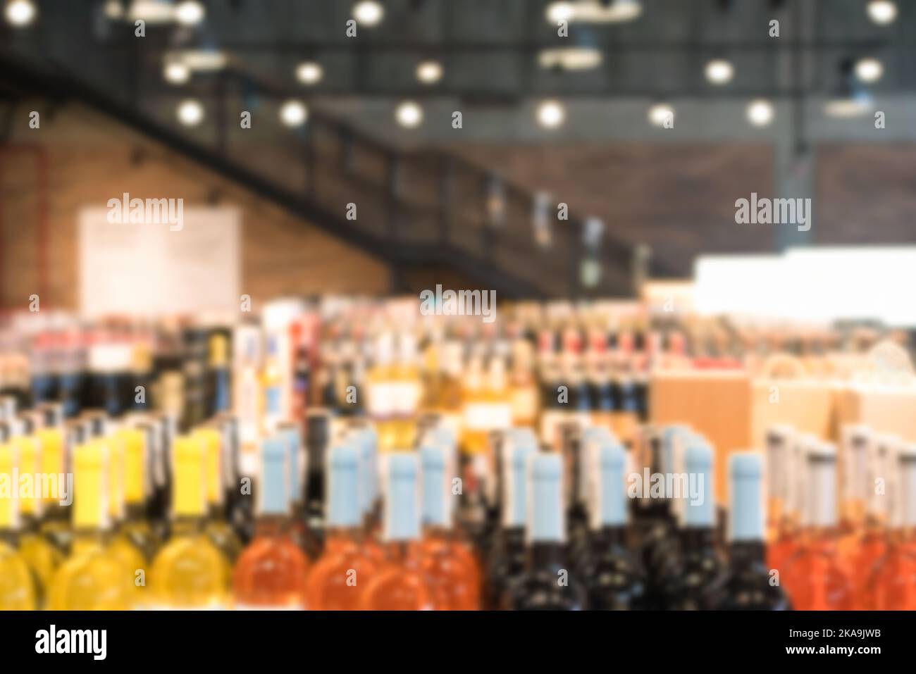 Many blurred bottles with alcohol. Defocused wine bottles background ...