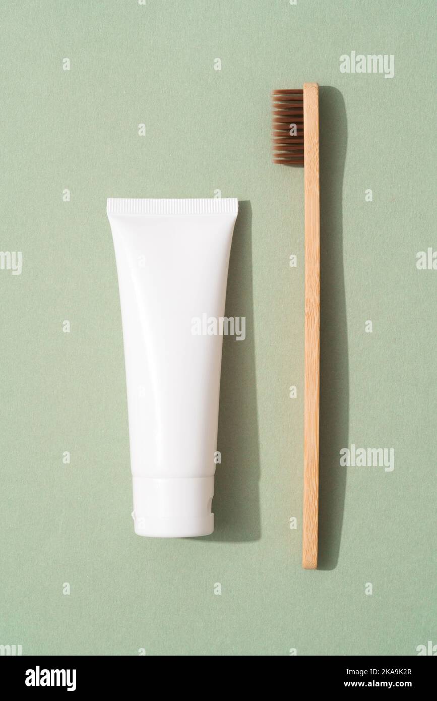Vertical image of wooden bamboo toothbrush and tube with organic ...