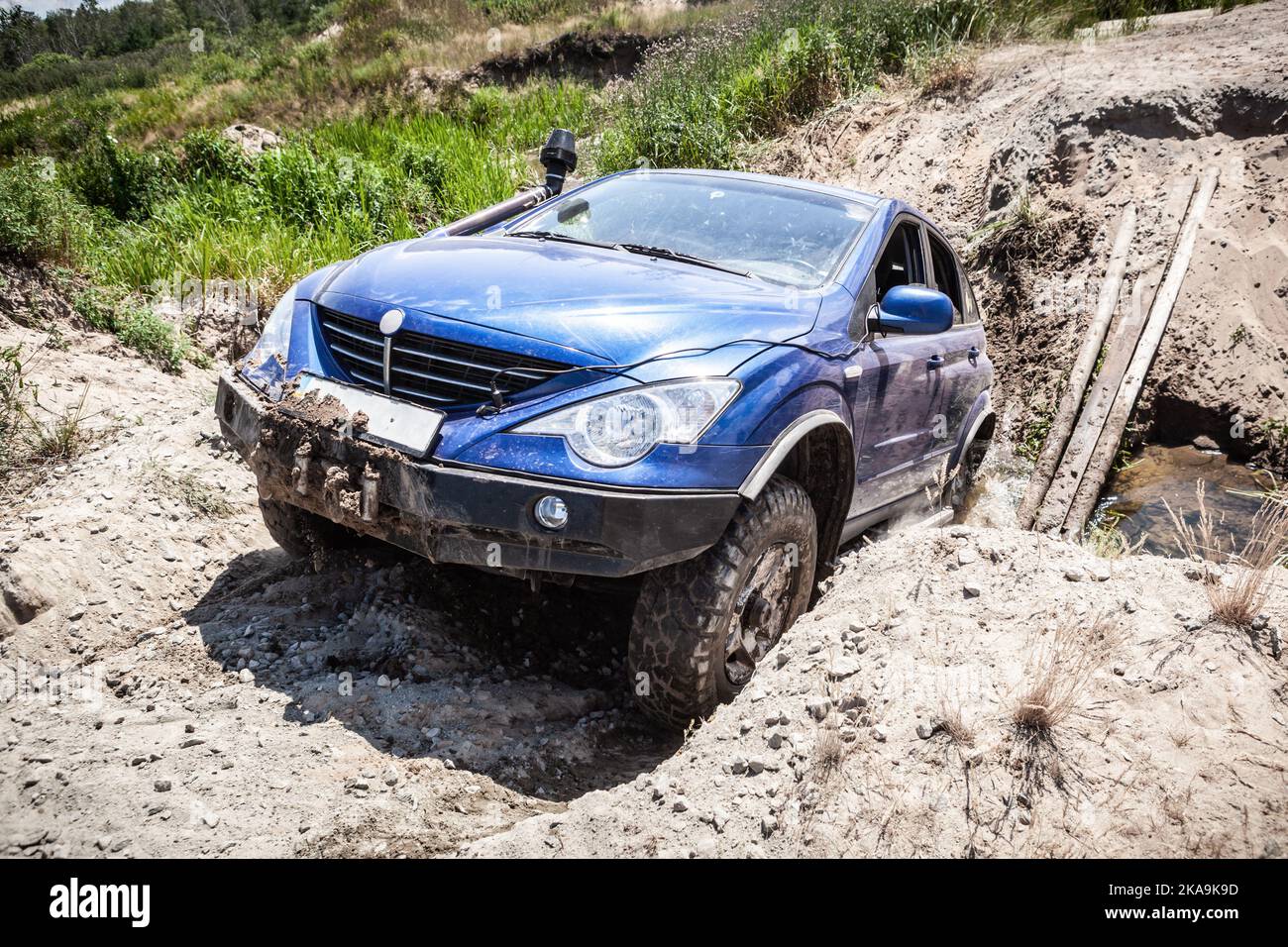 Heavy off-road racing car driving along the dusty road Stock Photo - Alamy