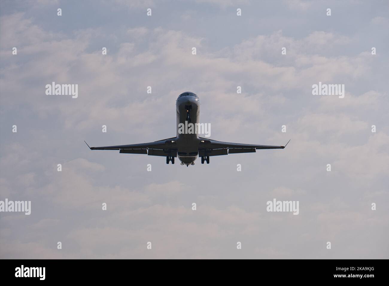 passenger plane on approach for landing, front view, from below Stock ...