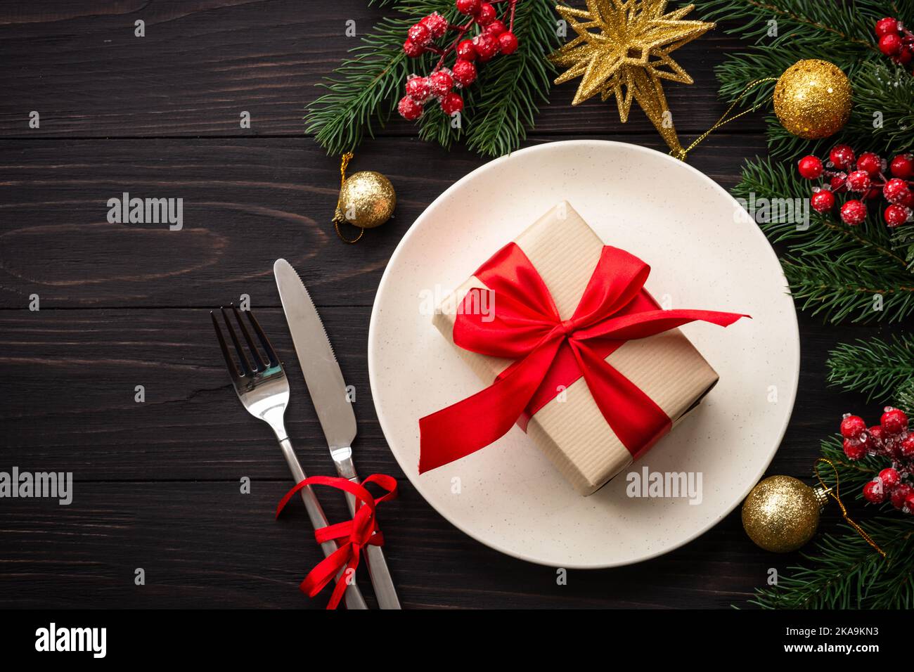 Christmas table setting with plate, cutlery and christmas decorations ...