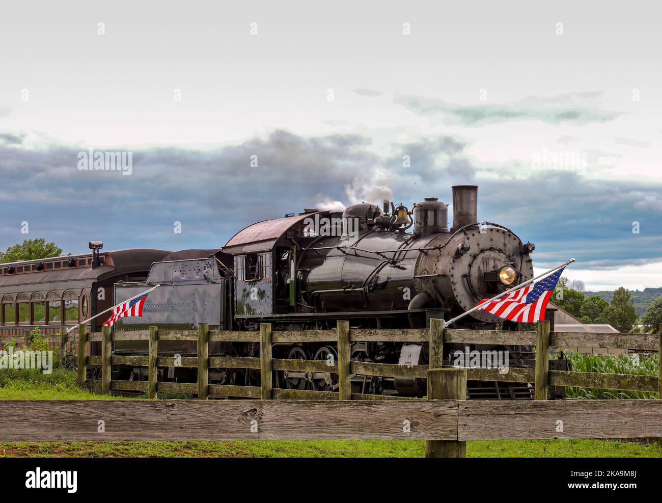 On a Cloudy Day American Flags are Waving in the Wind, on a Fence ...