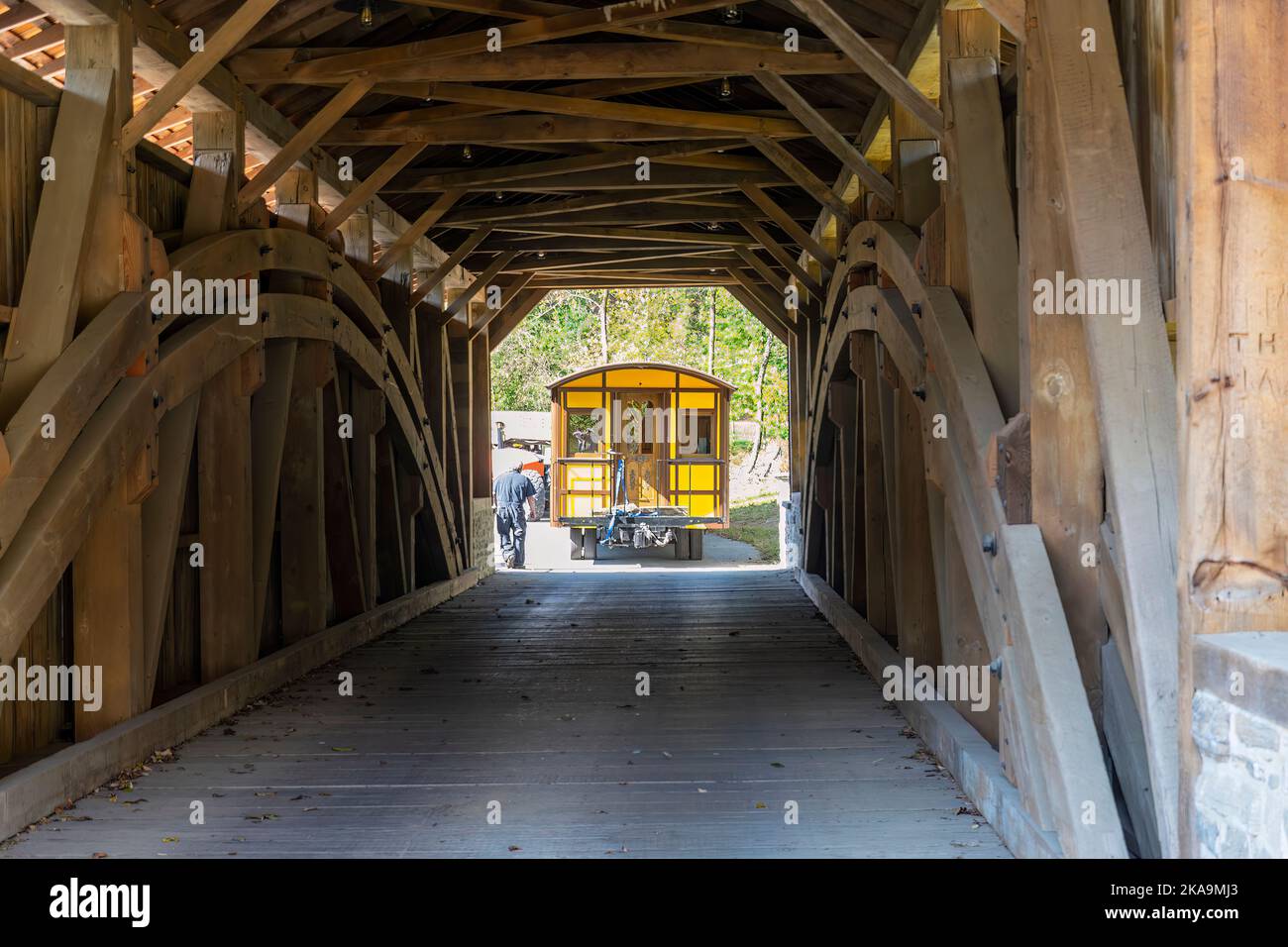 Installing a New Yellow Passenger Antique Coach Thru a Cover Bridge on ...