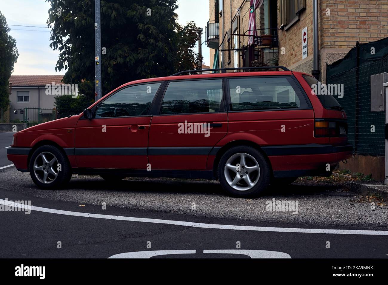 Red Volkswagen Passat parked on a crossing between streets Stock Photo ...