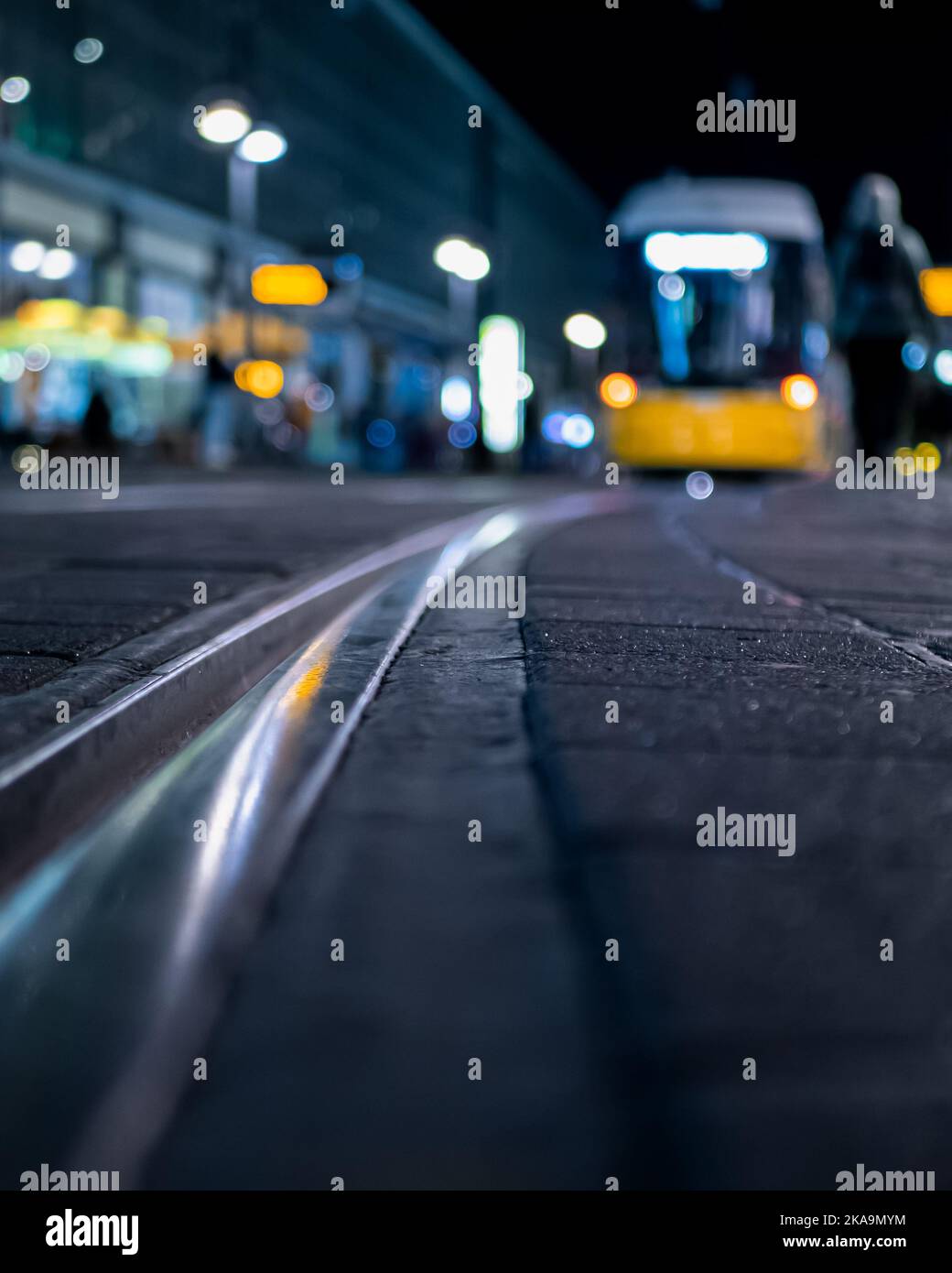 A blurred train with train tracks in Berlin by night Stock Photo - Alamy
