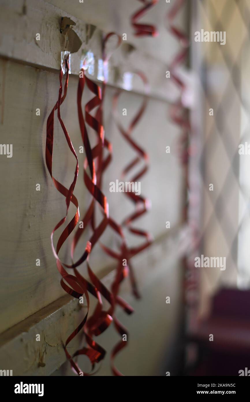 Decorations made with ribbons are hanged on the wall Stock Photo - Alamy