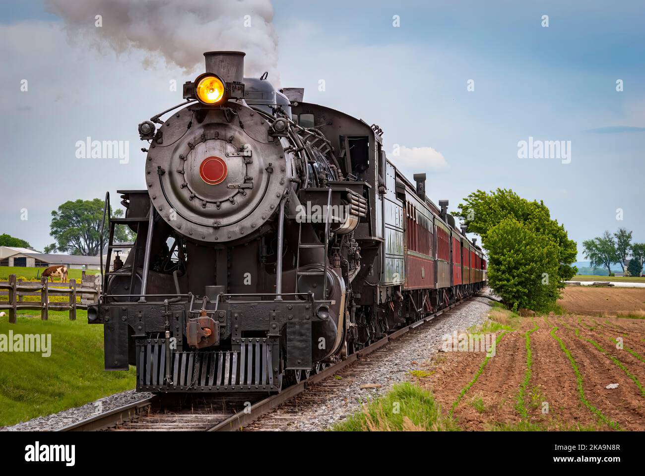 View of a Restored Steam Train Approaching Head-On Blowing Smoke and ...