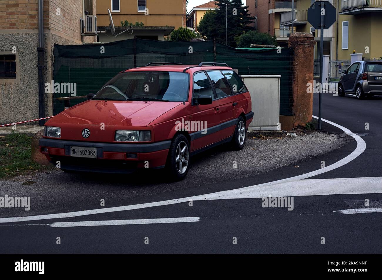 Red Volkswagen Passat parked on a crossing between streets Stock Photo ...