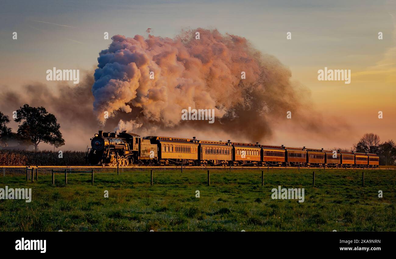 A View of an Antique Steam Passenger Train Approaching at Sunrise With ...