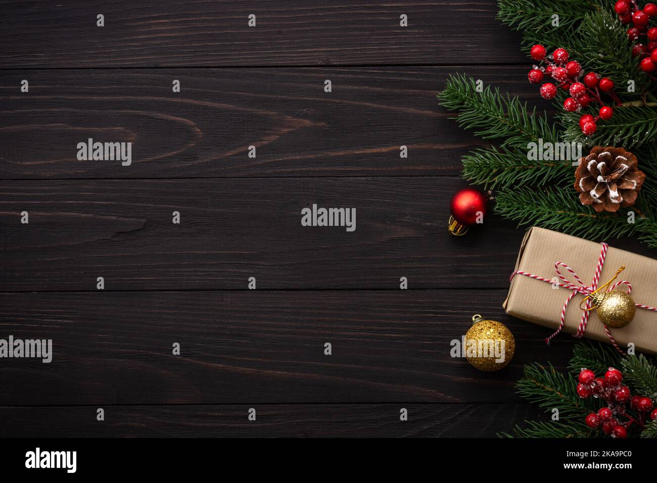Christmas background on wooden. Fir tree brunch and red decorations ...