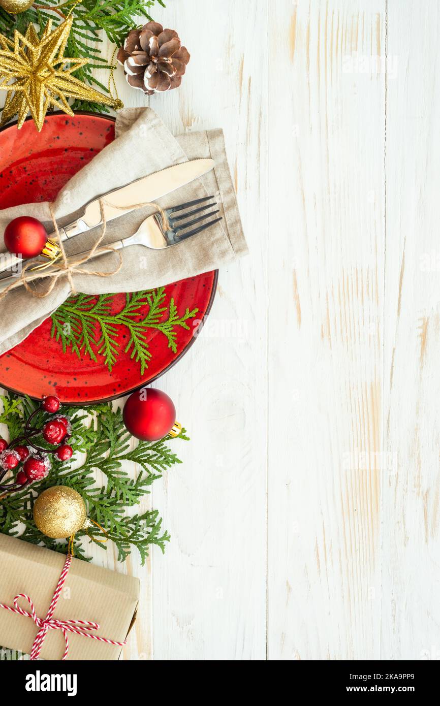 Christmas table setting with plate, cutlery and christmas decorations ...
