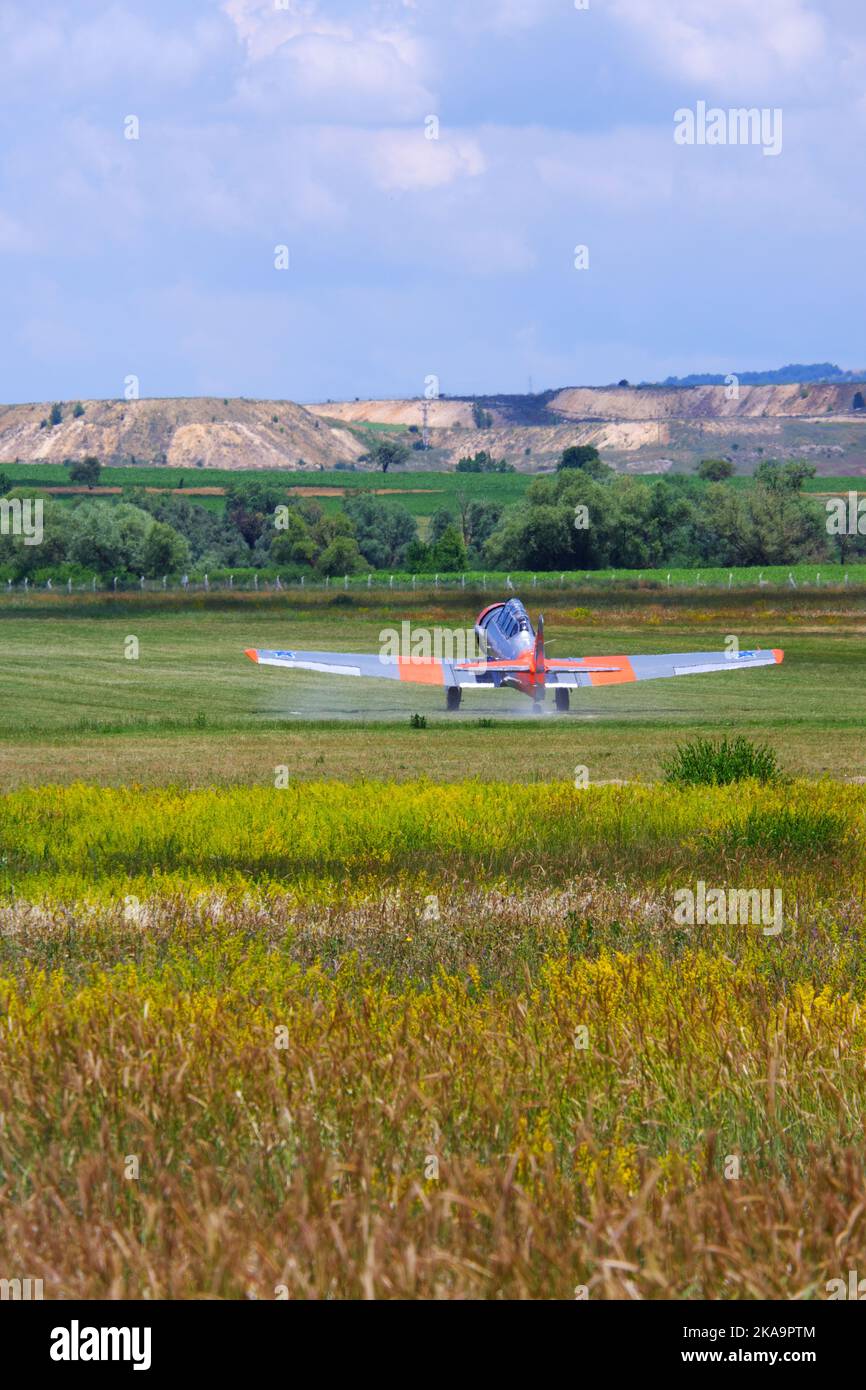 Plane ready for take off over hills. waiting on grass outdoor in nature ...