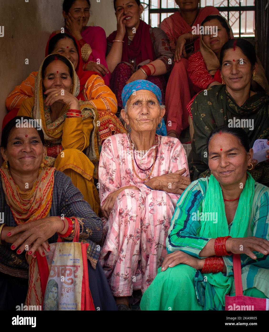 A group of Himalayan women in traditional Indian clothing sitting ...