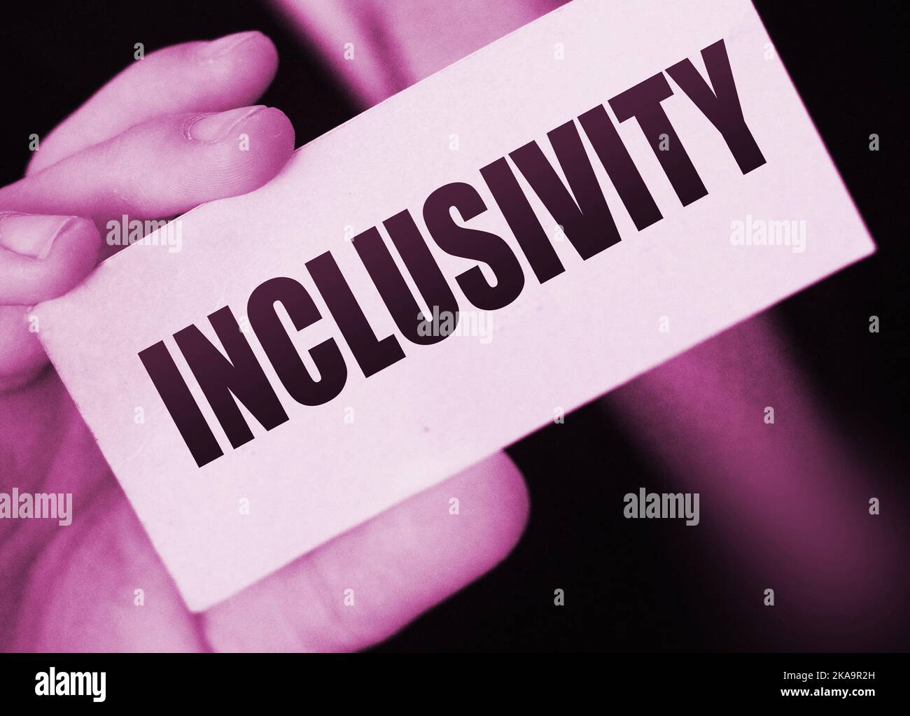 Inclusivity written on a card in businessman's hand. Diversity and ...
