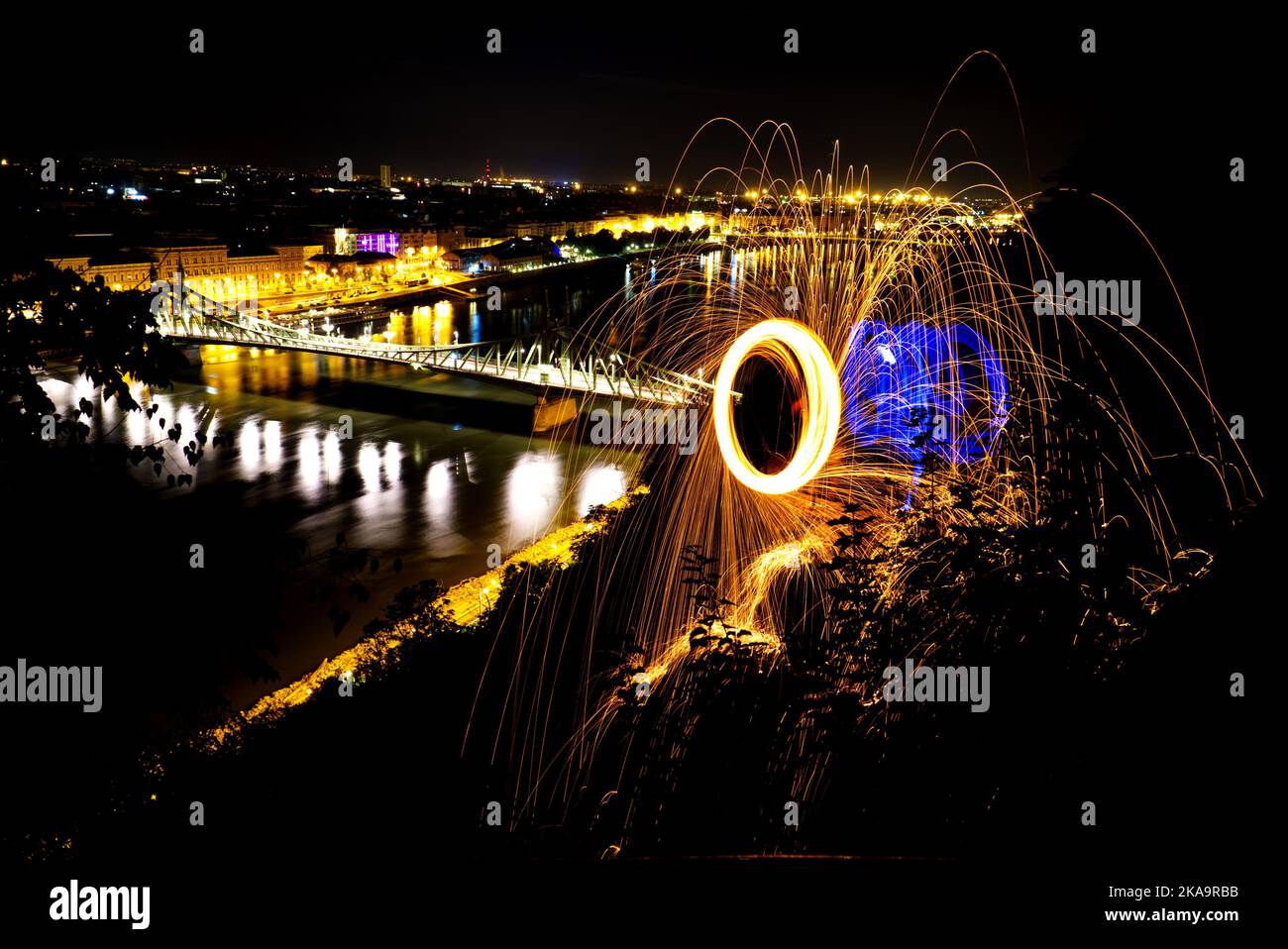 A bright golden freeze light on top of the city at night with lights on ...