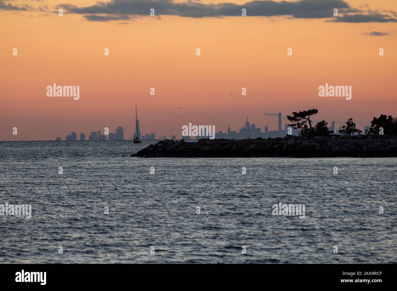 A breathtaking sunset view over the ocean with the New York City ...