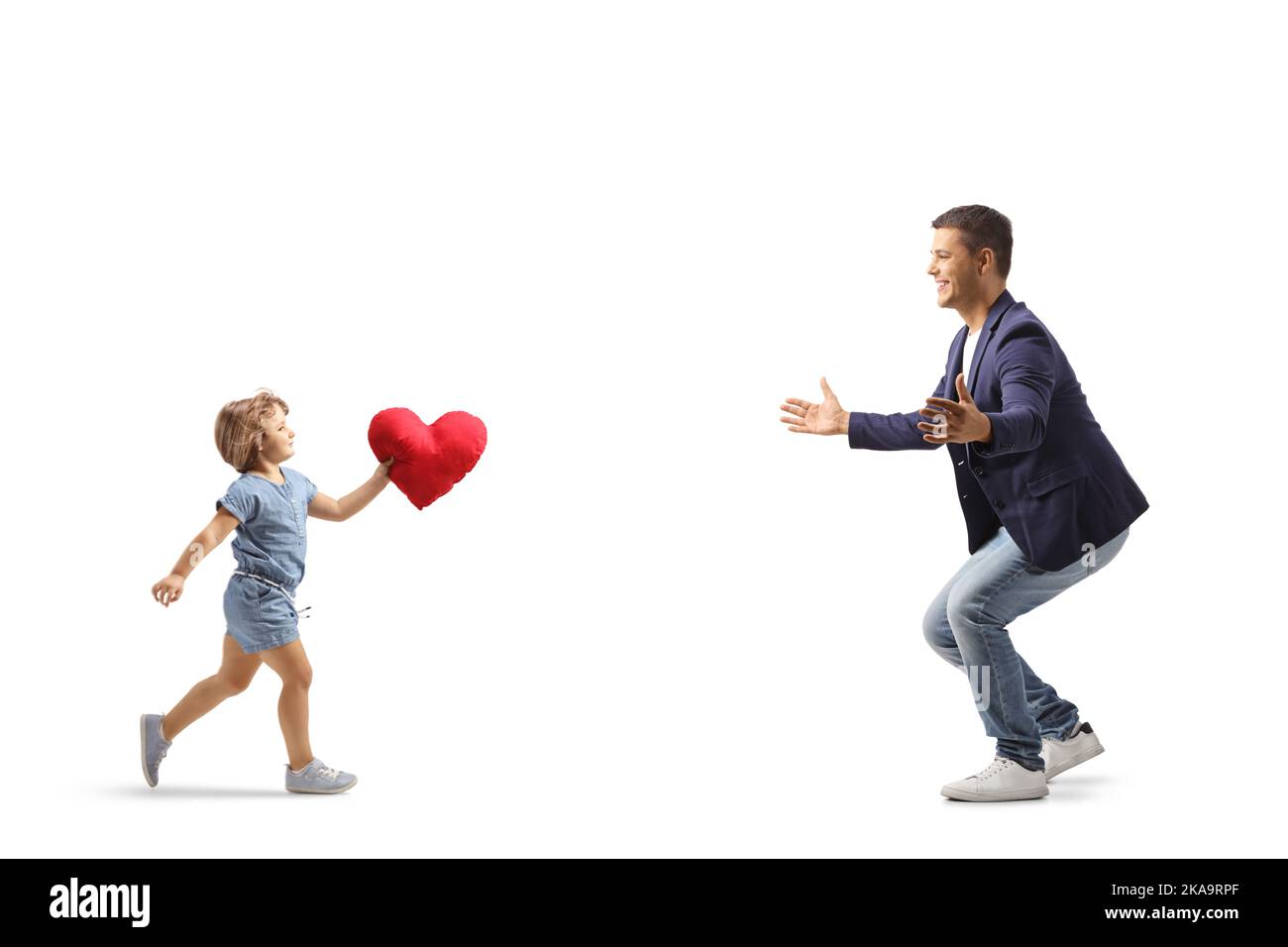 Full length profile shot of a little girl running with a red heart ...