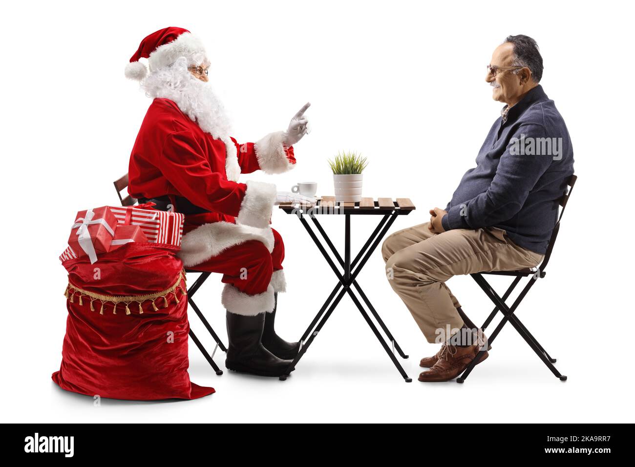 Santa Claus talking to a mature man in a cafe isolated on white ...