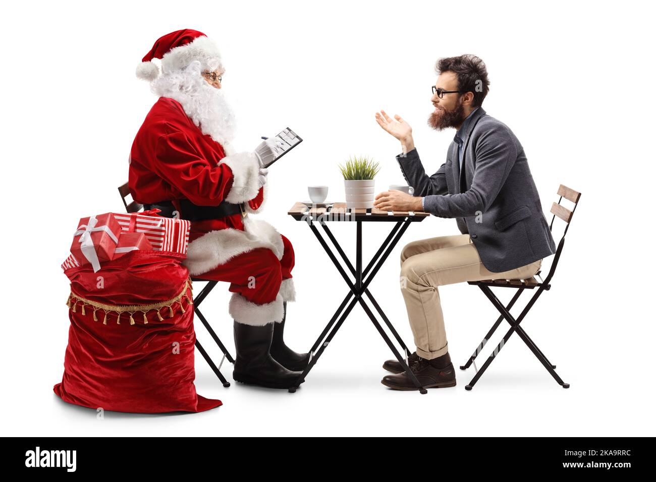 Man sitting in a cafe with santa claus isolated on white background ...