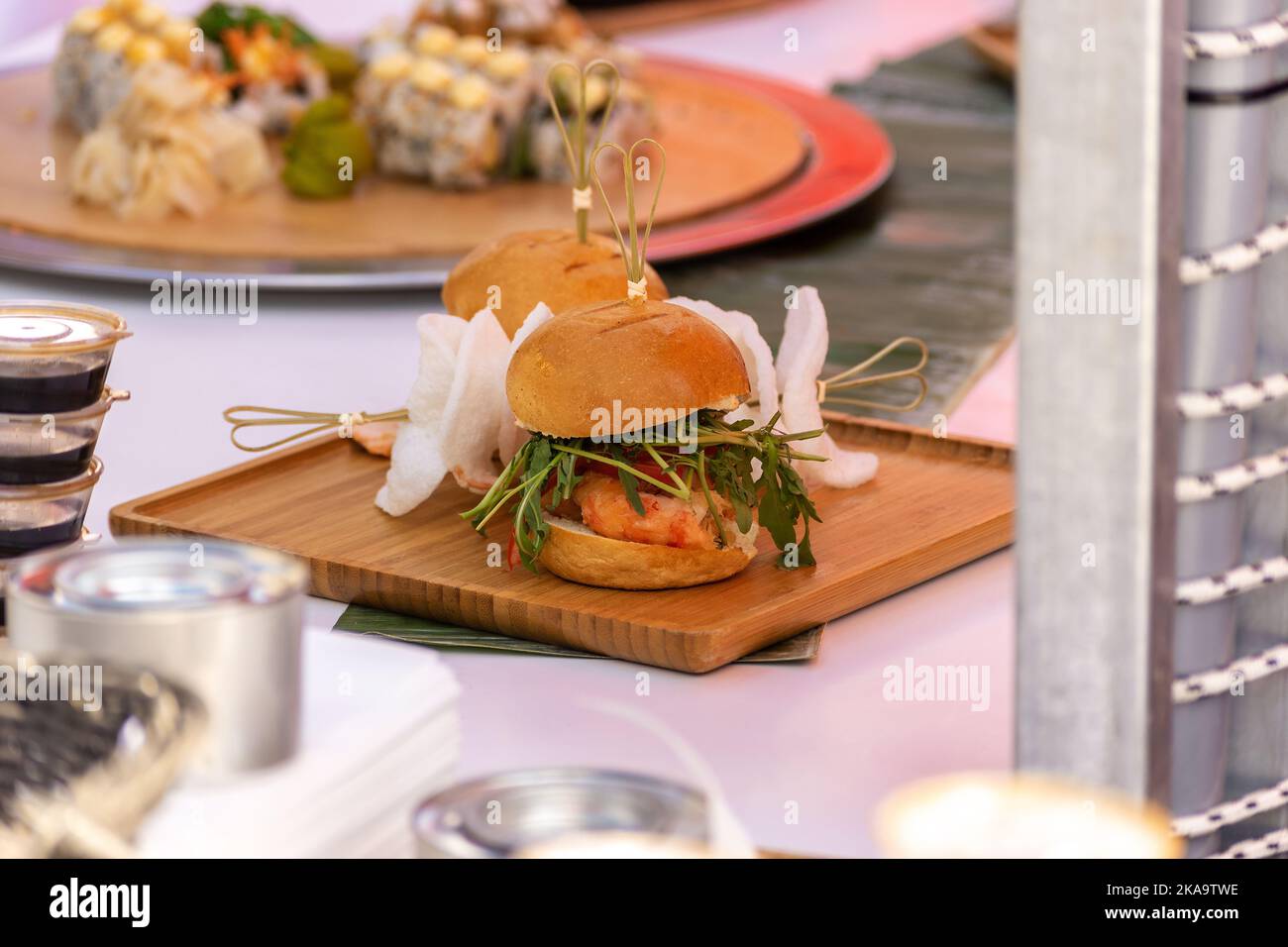Fresh delicious grilled burgers on wooden table. Street food festival ...