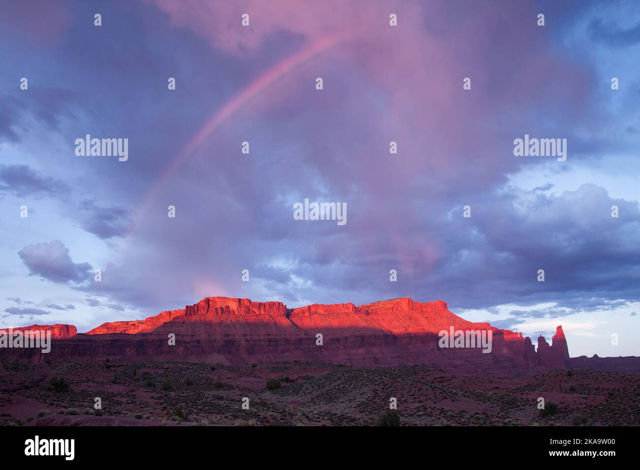 Colorful storm clouds & a rainbow over Wray Mesa and the Fisher Towers ...