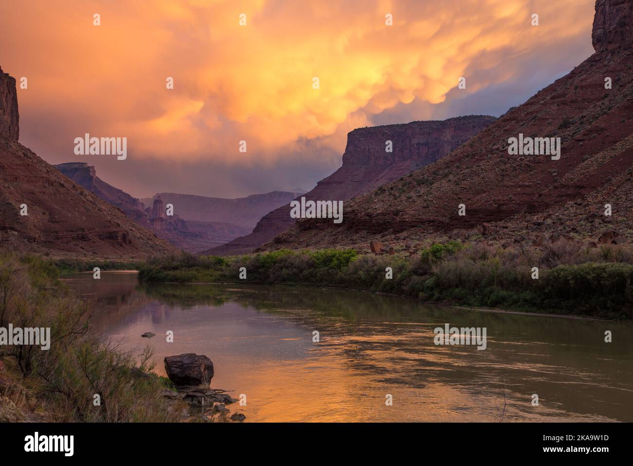 Colorful mammatus storm clouds at sunset over the Fisher Towers and the ...