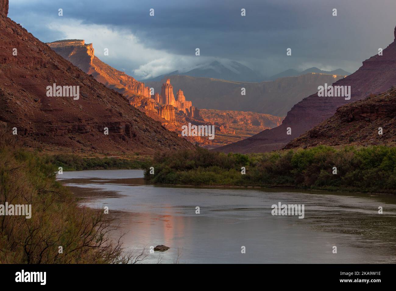 Storm clouds and sunset light on the Fisher Towers over the Colorado ...