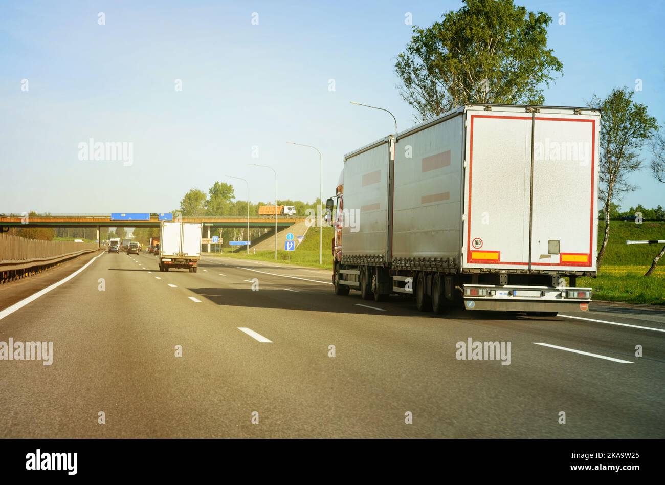 Trucks with containers, dump trucks and cars on the highway. Freight ...