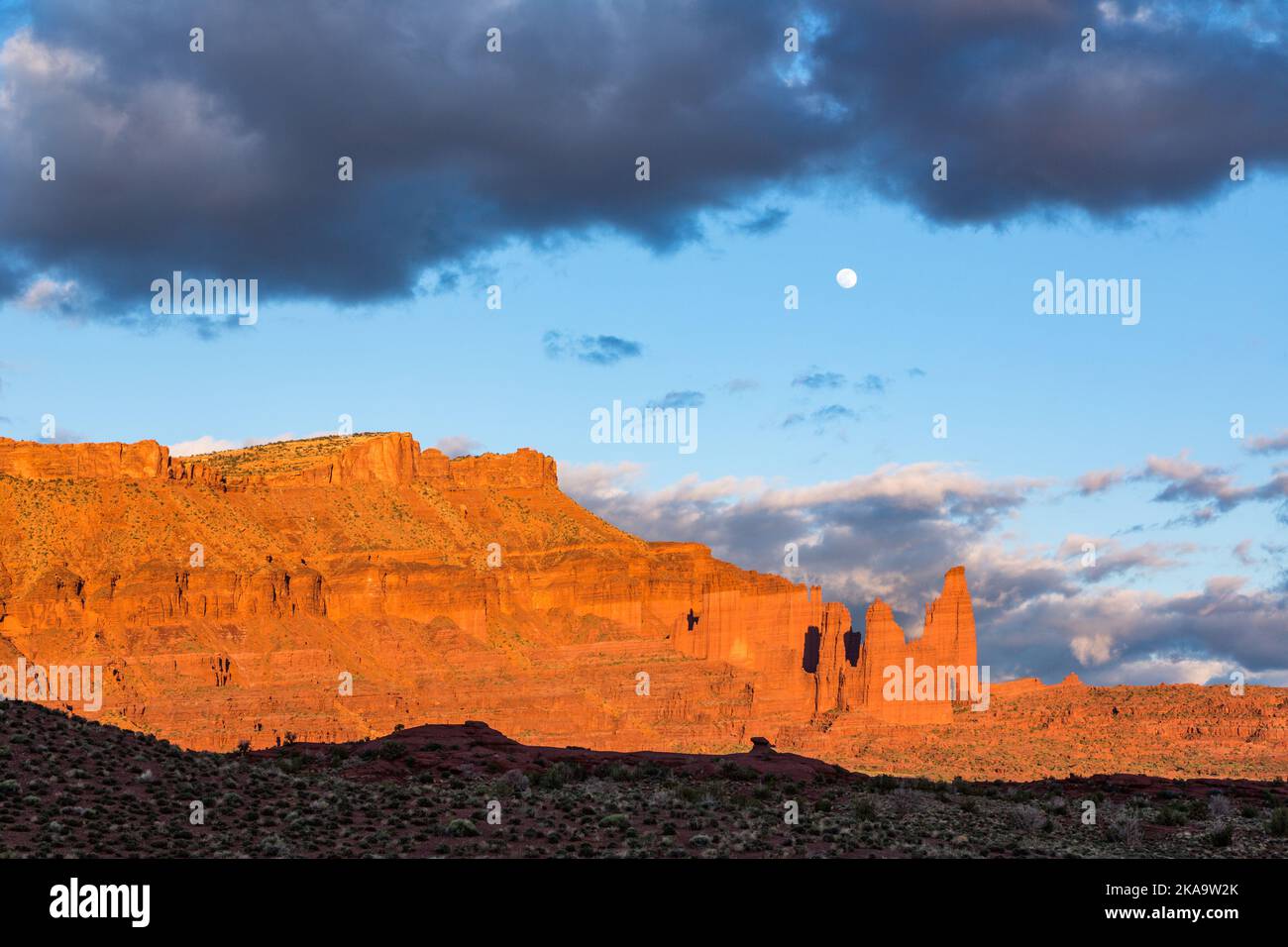 Rising moon over the Fisher Towers, eroded Cutler sandstone rock ...
