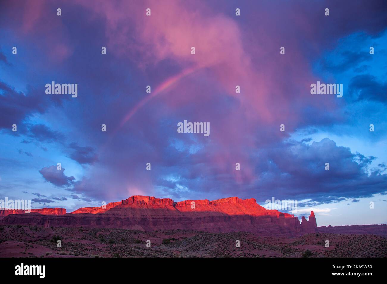 Colorful storm clouds & a rainbow over Wray Mesa and the Fisher Towers ...