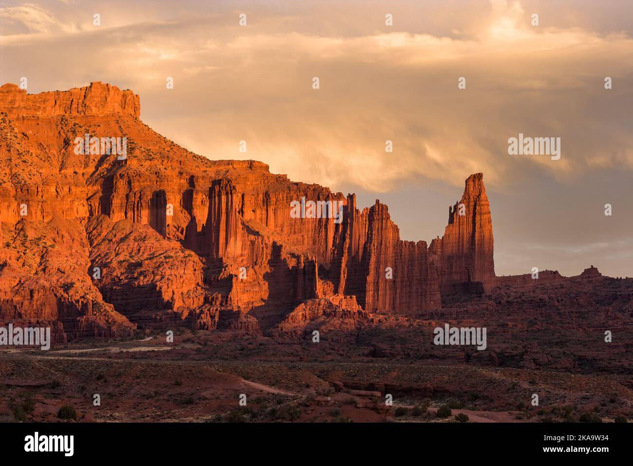 Stormy clouds at sunset over Wray Mesa and the Fisher Towers, with the Titan at right, near Moab ...
