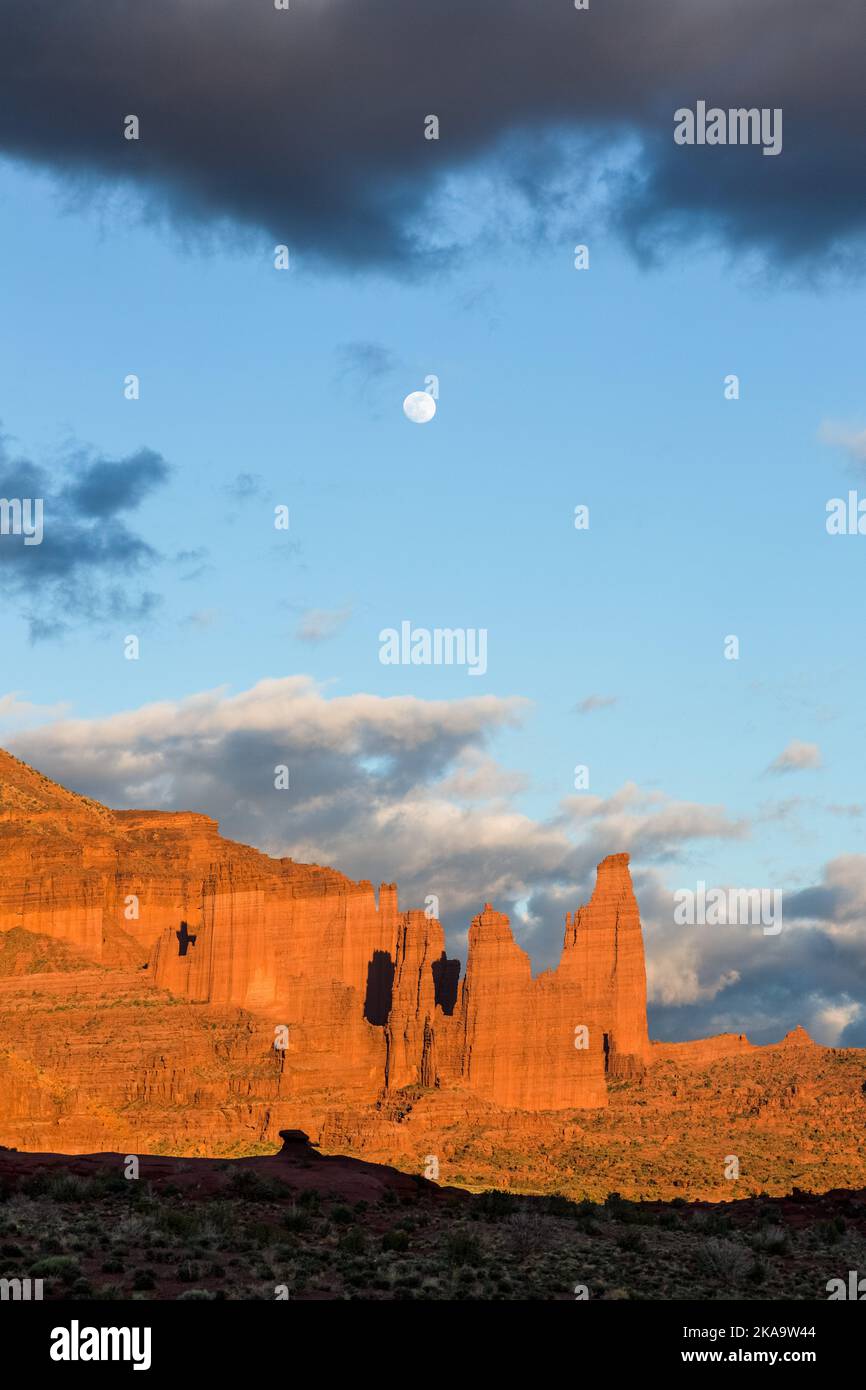 Rising moon over the Fisher Towers, eroded Cutler sandstone rock formations at sunset near Moab ...