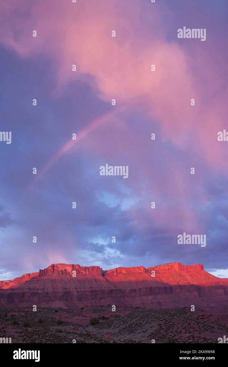Colorful storm clouds & a rainbow over Wray Mesa and the Fisher Towers ...