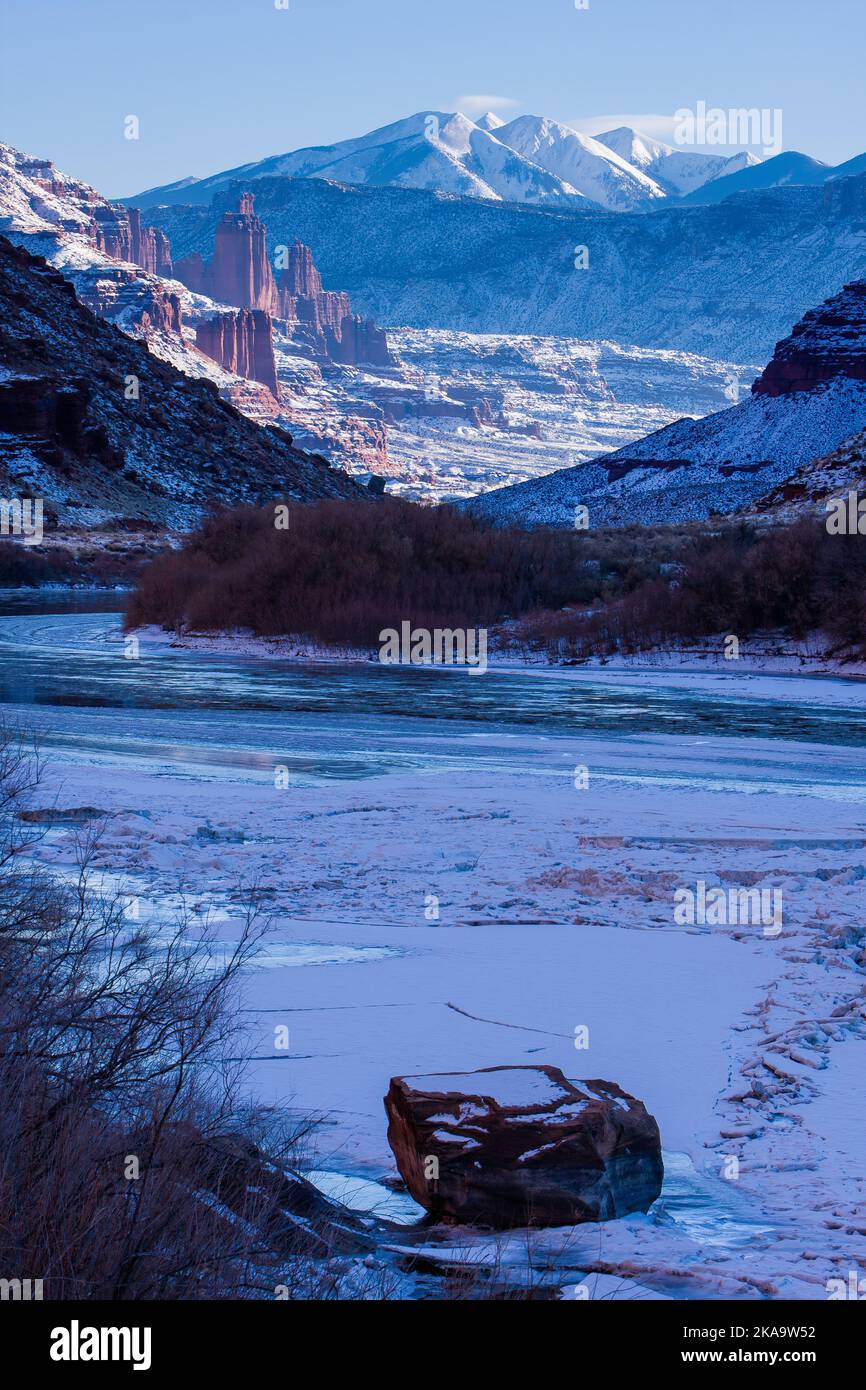 Fisher Towers over the icy Colorado River at sunset in winter with the ...