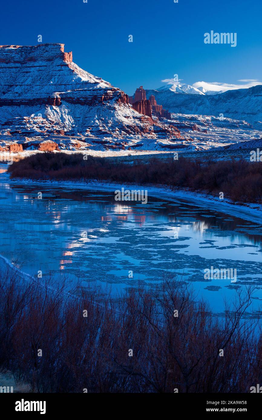 Fisher Towers over the icy Colorado River at sunset in winter with the ...
