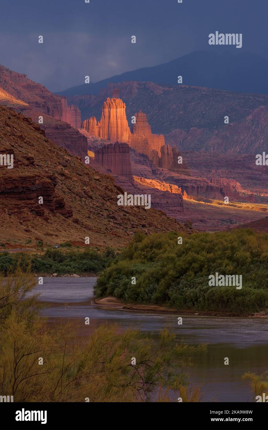 Storm clouds and sunset light on the Fisher Towers over the Colorado ...