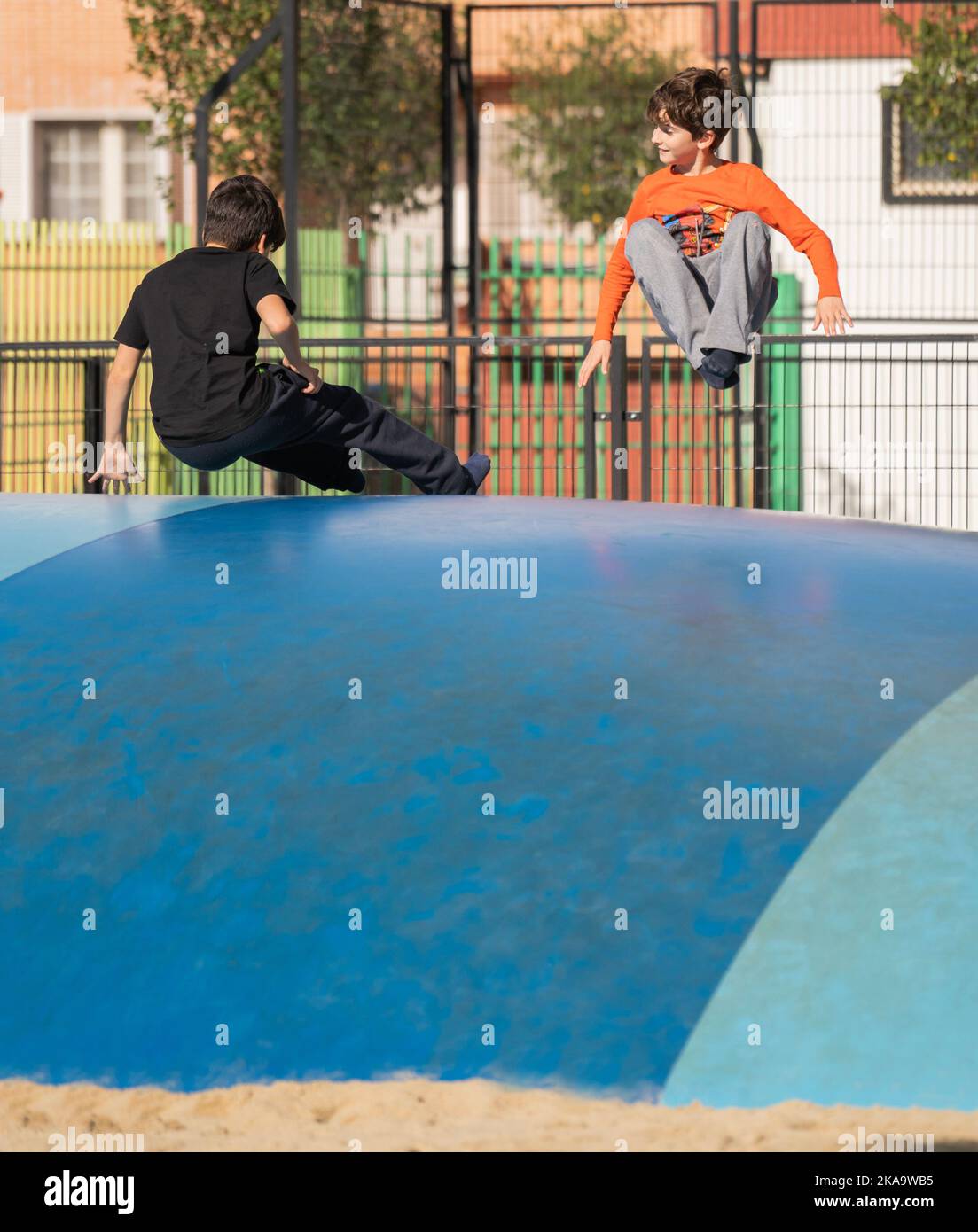 Children jumping in air in park hi-res stock photography and images - Alamy