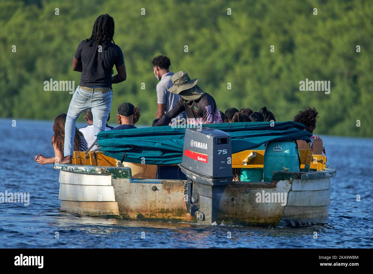 A beautiful shot of a floating boat in a river with a full of people ...