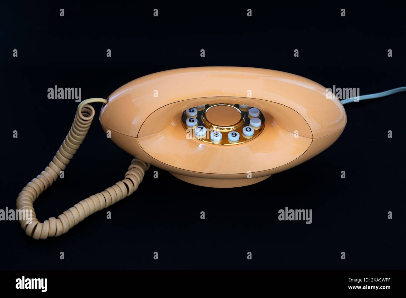 Peach coloured 1970's Modern telephone handset Stock Photo - Alamy